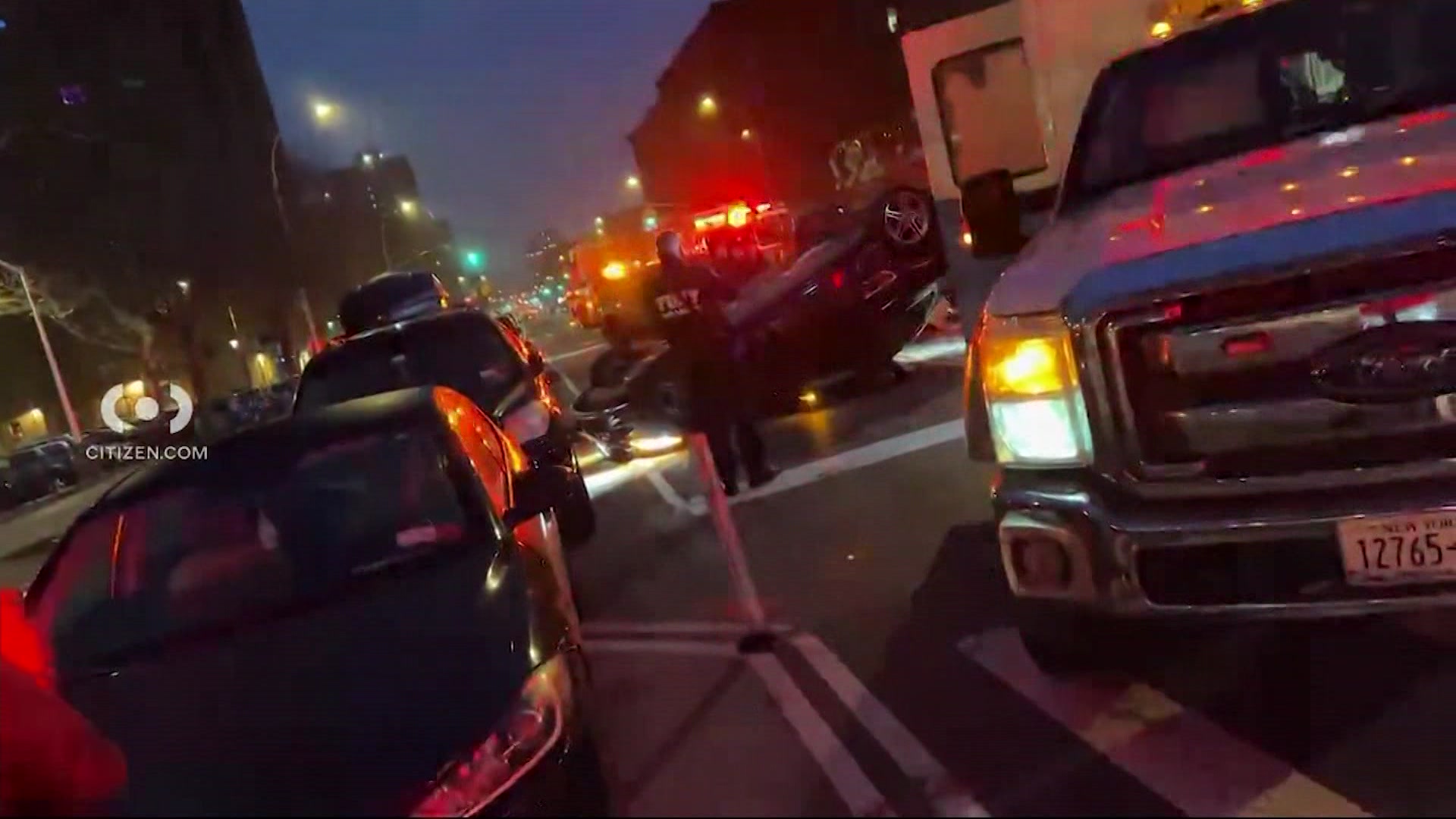Police: Vehicle flips over after crashing into 2 parked cars in Mott Haven