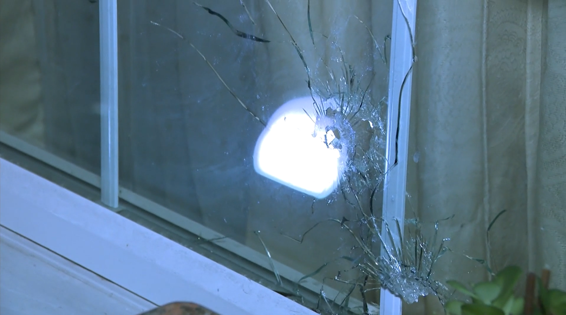 NYPD: Woman struck by stray bullet through window in her home