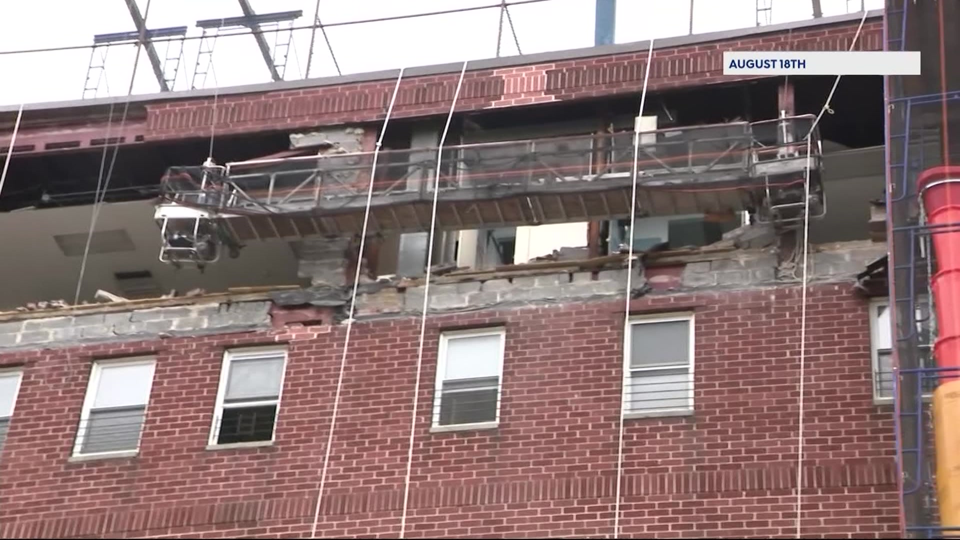 Partial building collapse sends bricks onto sidewalk, nearby buildings ...