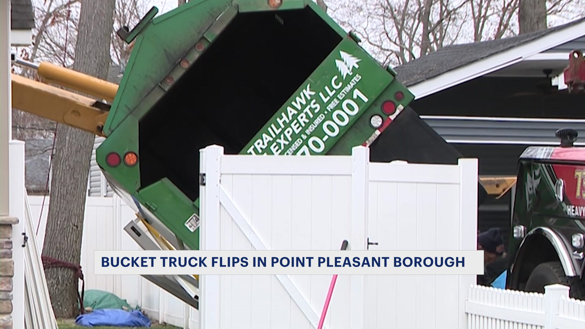 Bucket truck flips over into Toms River backyard